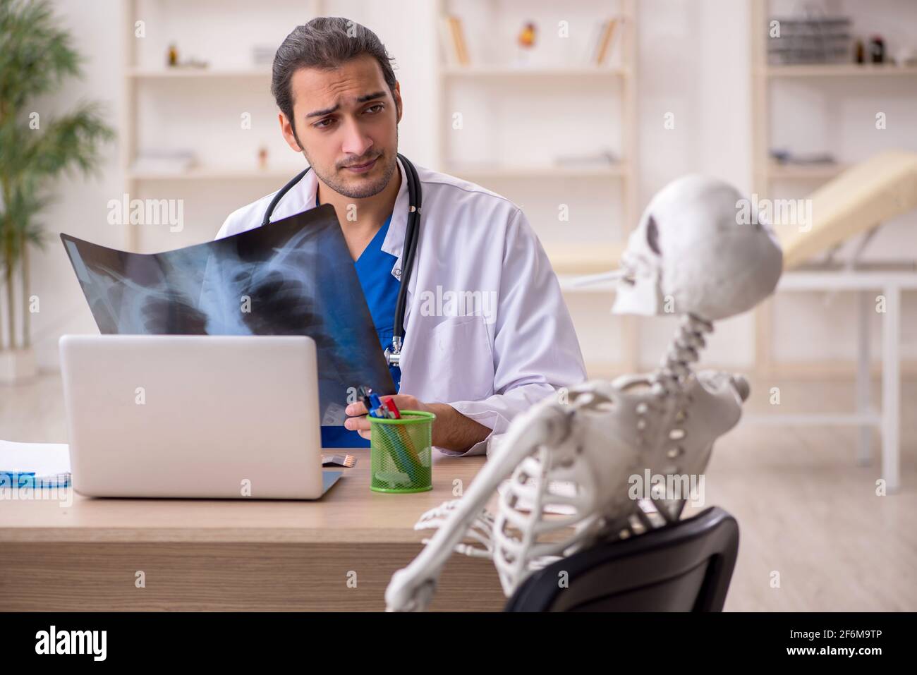 Young doctor radiologist and skeleton patient in the clinic Stock Photo ...