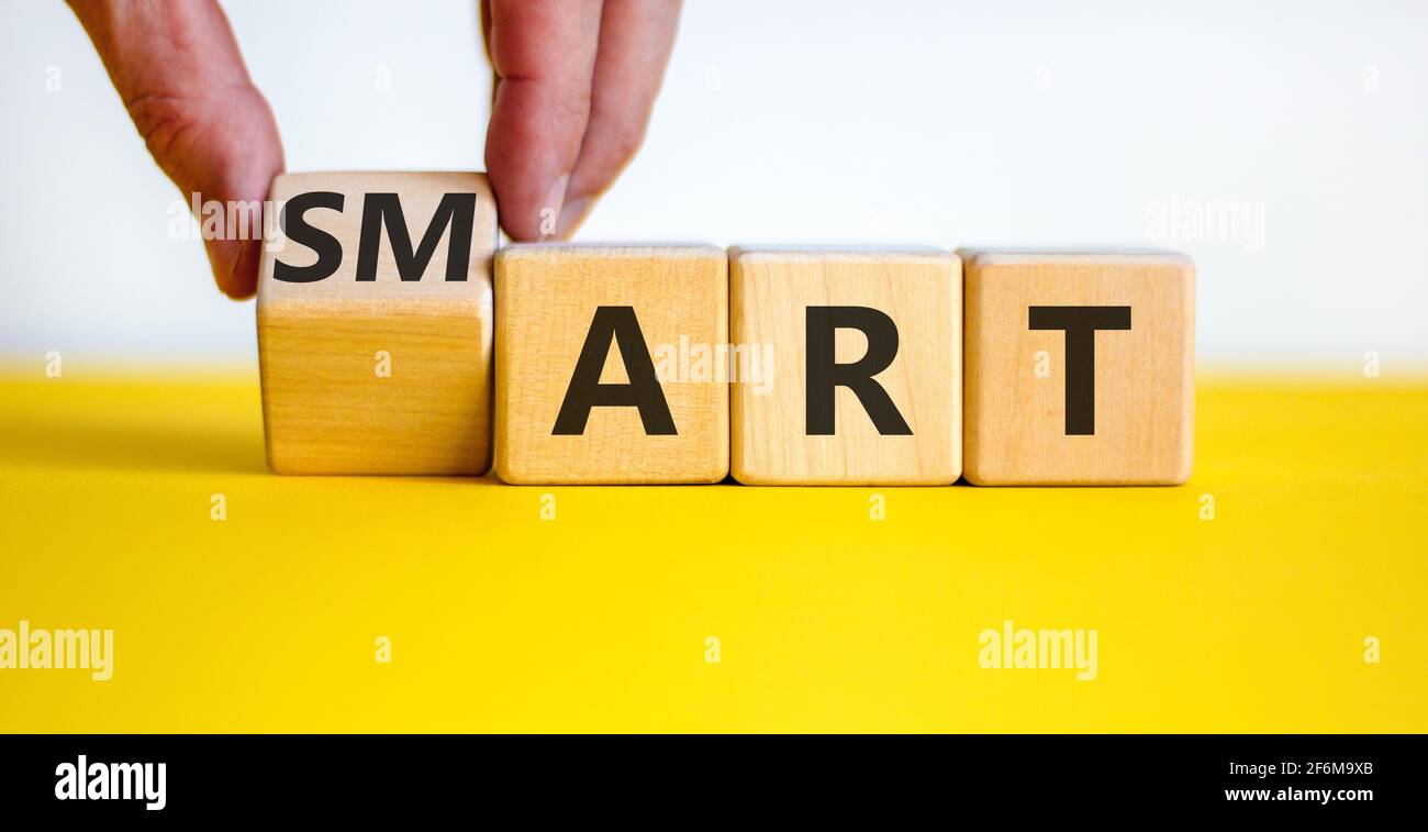 Smart art symbol. Businessman turns the cube and changes the word ...