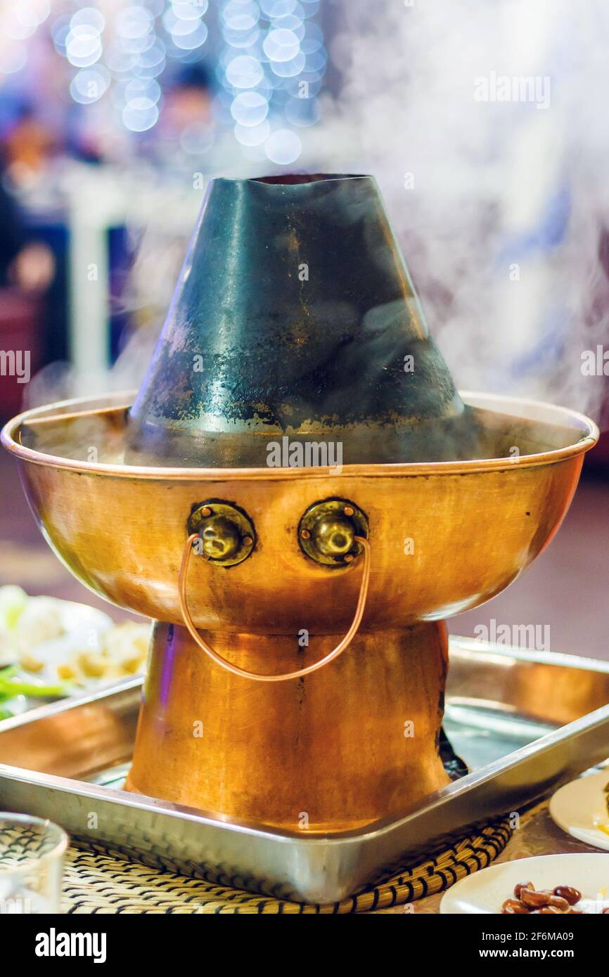 Asian traditional double hot pot close-up with lettuce leaves Stock ...