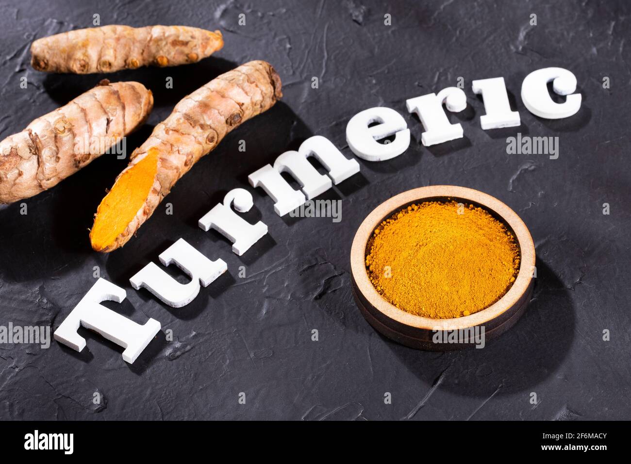 Curcuma longa - Roots and turmeric powder. Text space Stock Photo - Alamy