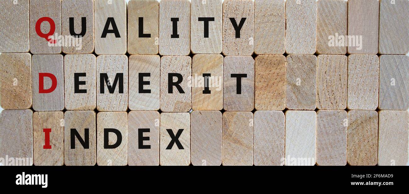QDI, quality demerit index symbol. Wooden blocks with words 'QDI ...