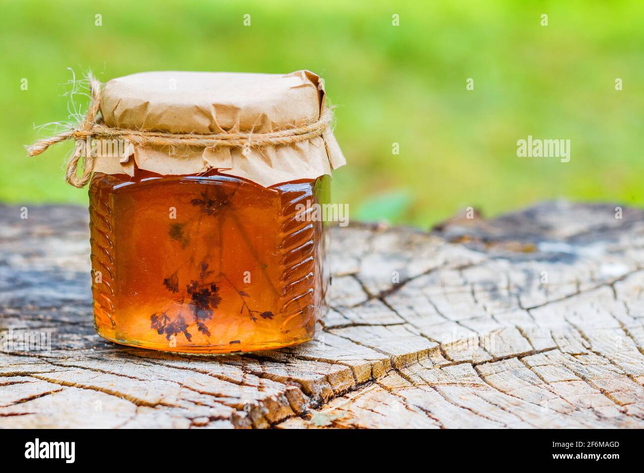 Bank with jam dandelion close-up on wooden table with copyspace. Useful ...