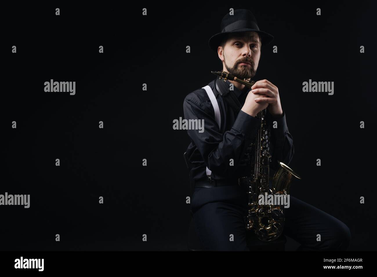 Artist posing with saxophone Stock Photo - Alamy