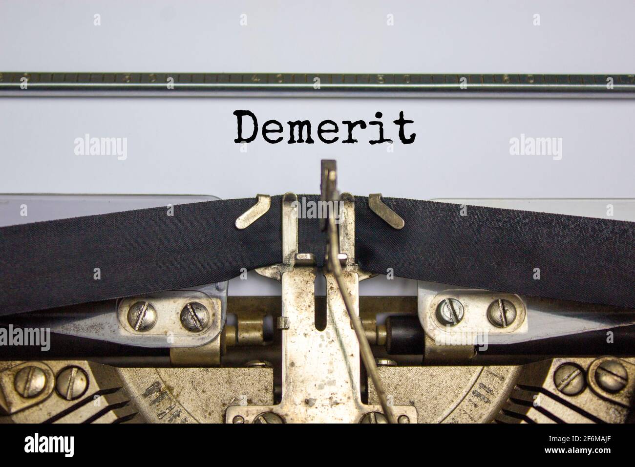 Demerit symbol. The word 'demerit' typed on retro typewriter. Business ...