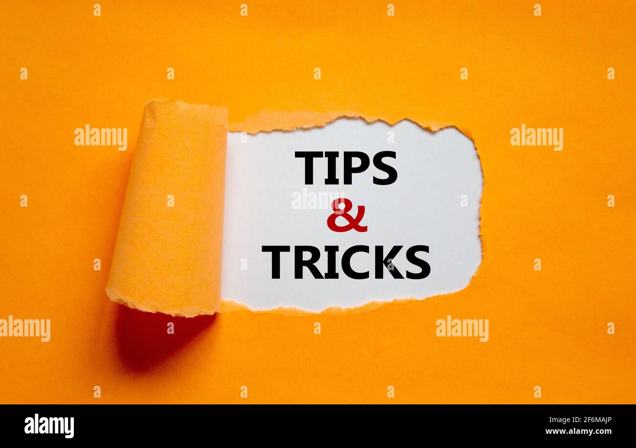 Tips and tricks symbol. Words 'Tips and tricks' appearing behind torn ...