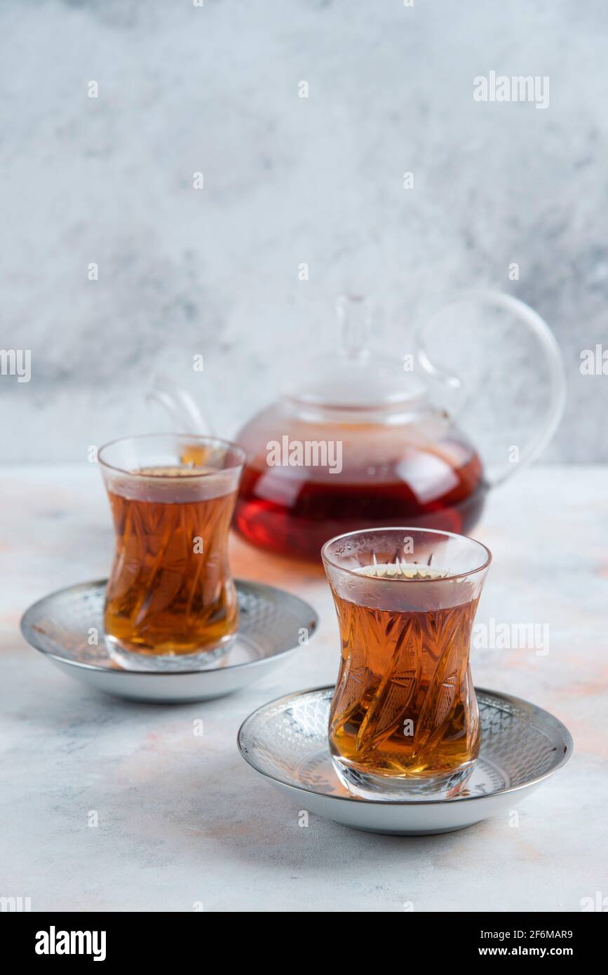 Vertical photo. Teapot and glass two glass tea on white background ...