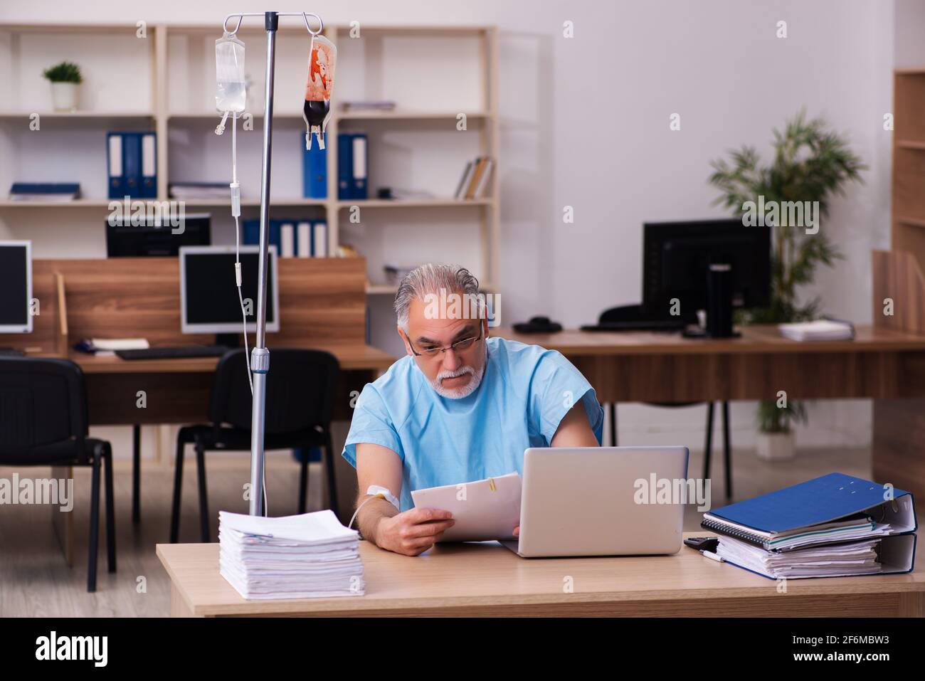 Old businessman employee in blood transfusion concept Stock Photo - Alamy