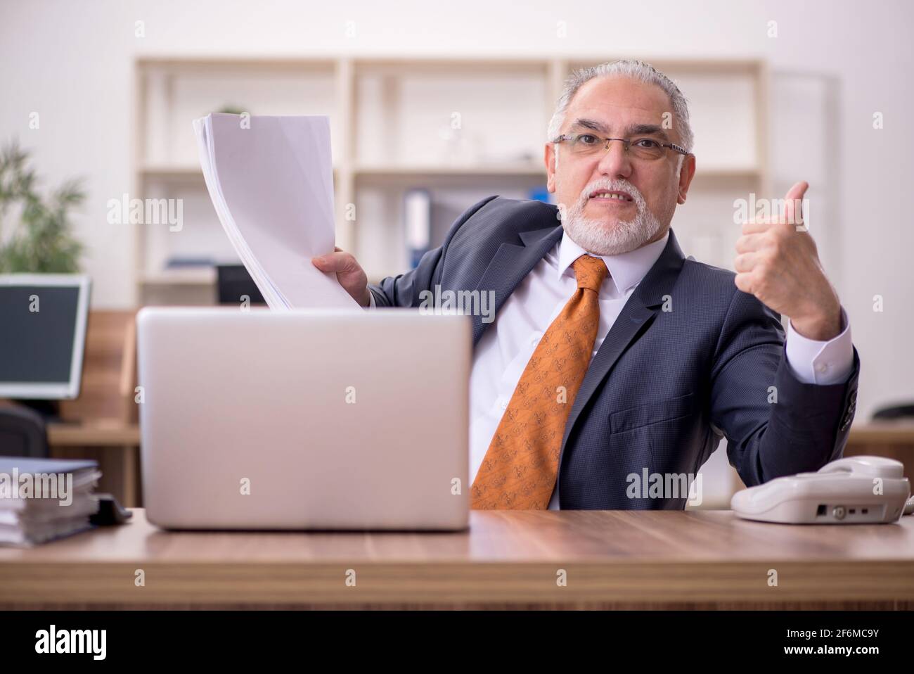Old employee working in the office Stock Photo - Alamy