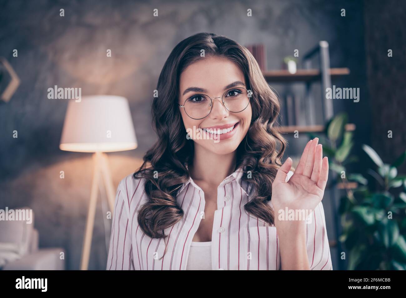 Photo Of Optimistic Brunette Curly Hairdo Lady Wave Hand Work From Home