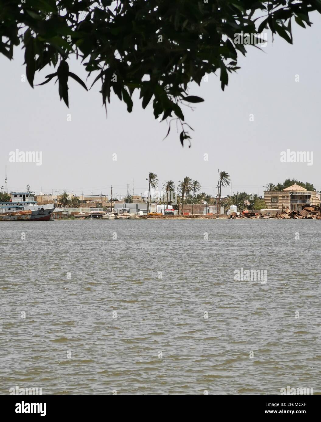 basra, Iraq - april 27, 2018: photo of boat in the river in basra city ...