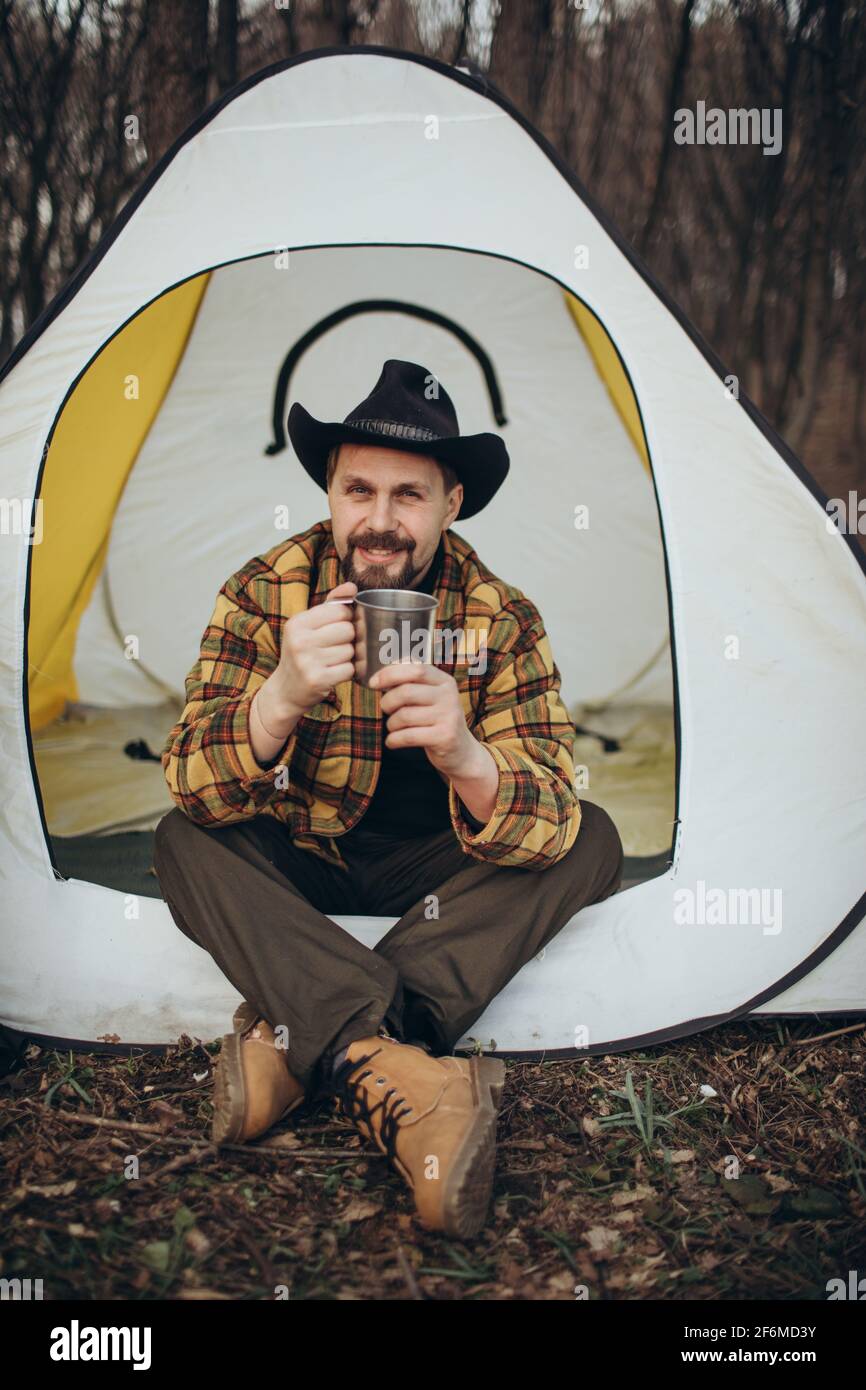 Man in forest with tent hi-res stock photography and images - Alamy
