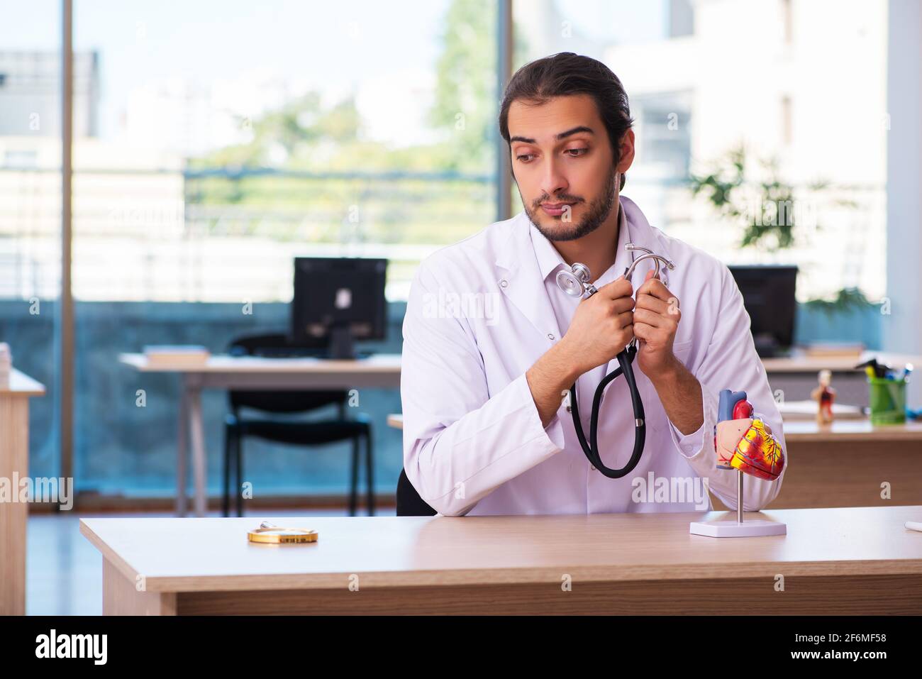 Young doctor cardiologist working in the clinic Stock Photo - Alamy