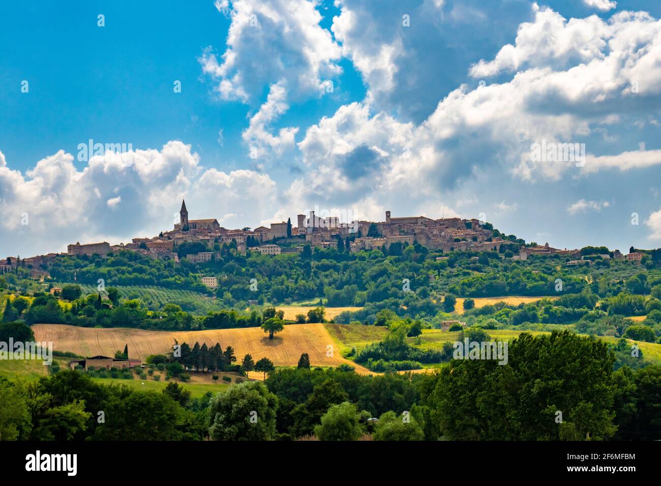 the skyline of the city of Todi and view of the surrounding hills with ...