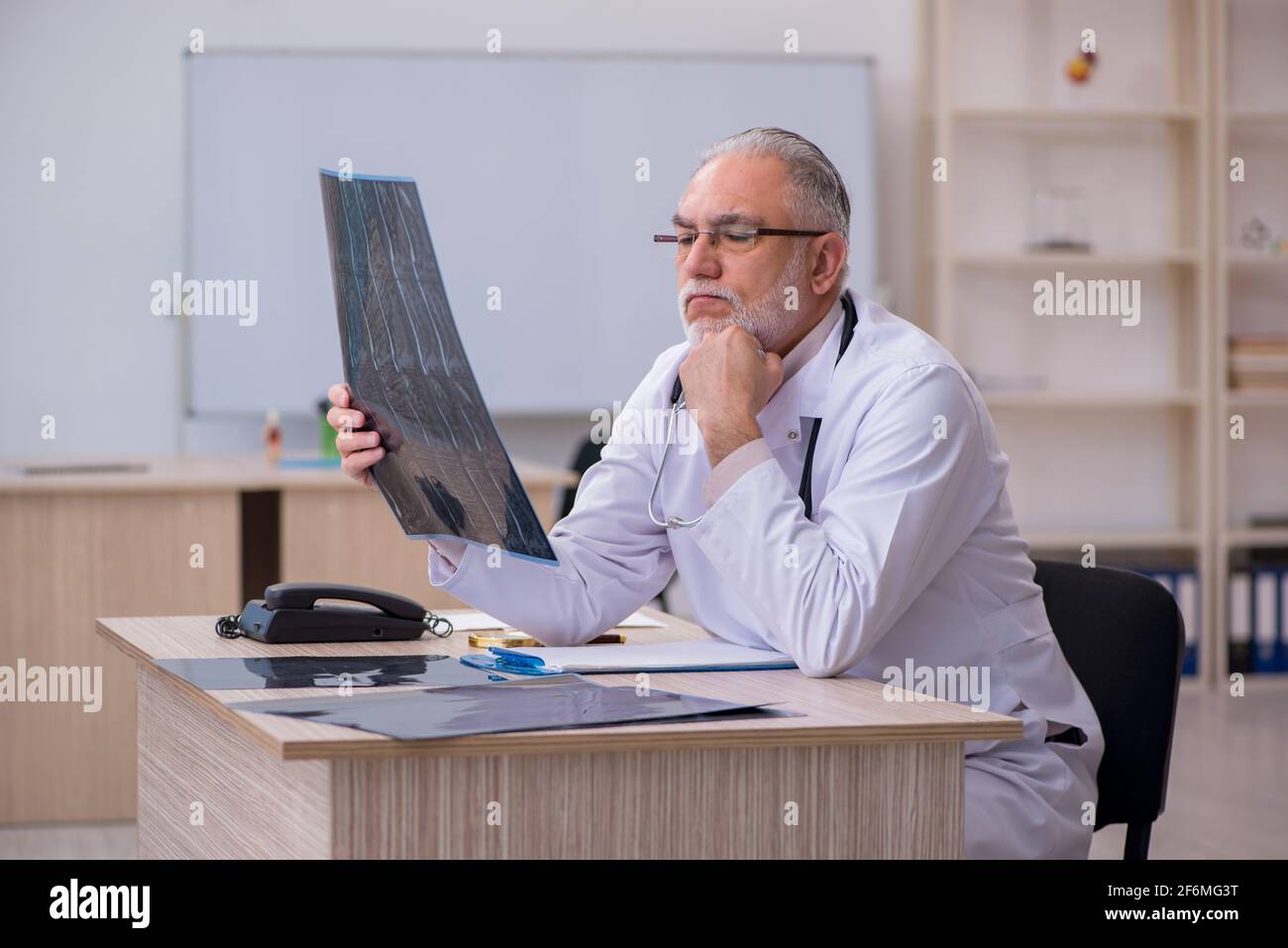 Old doctor radiologist working in the clinic Stock Photo - Alamy