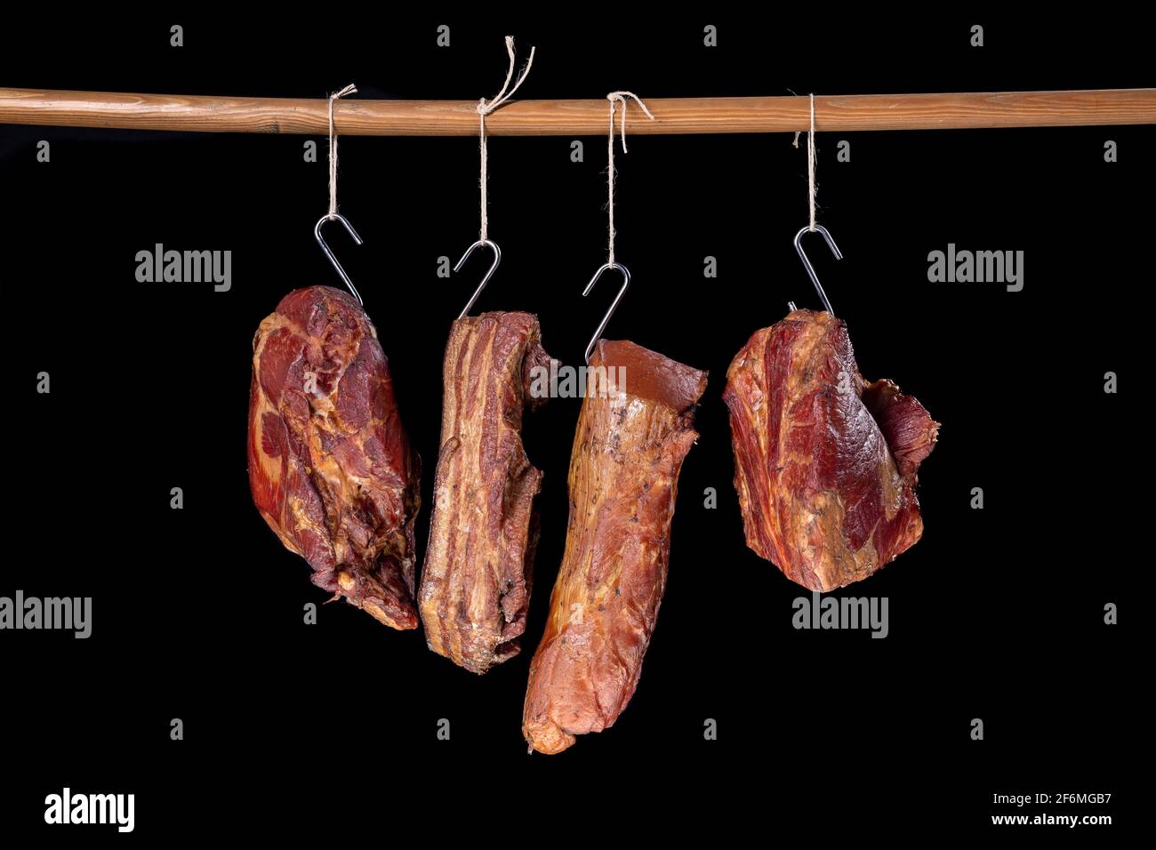 Delicious smoked meats suspended on a string. Meats prepared according ...