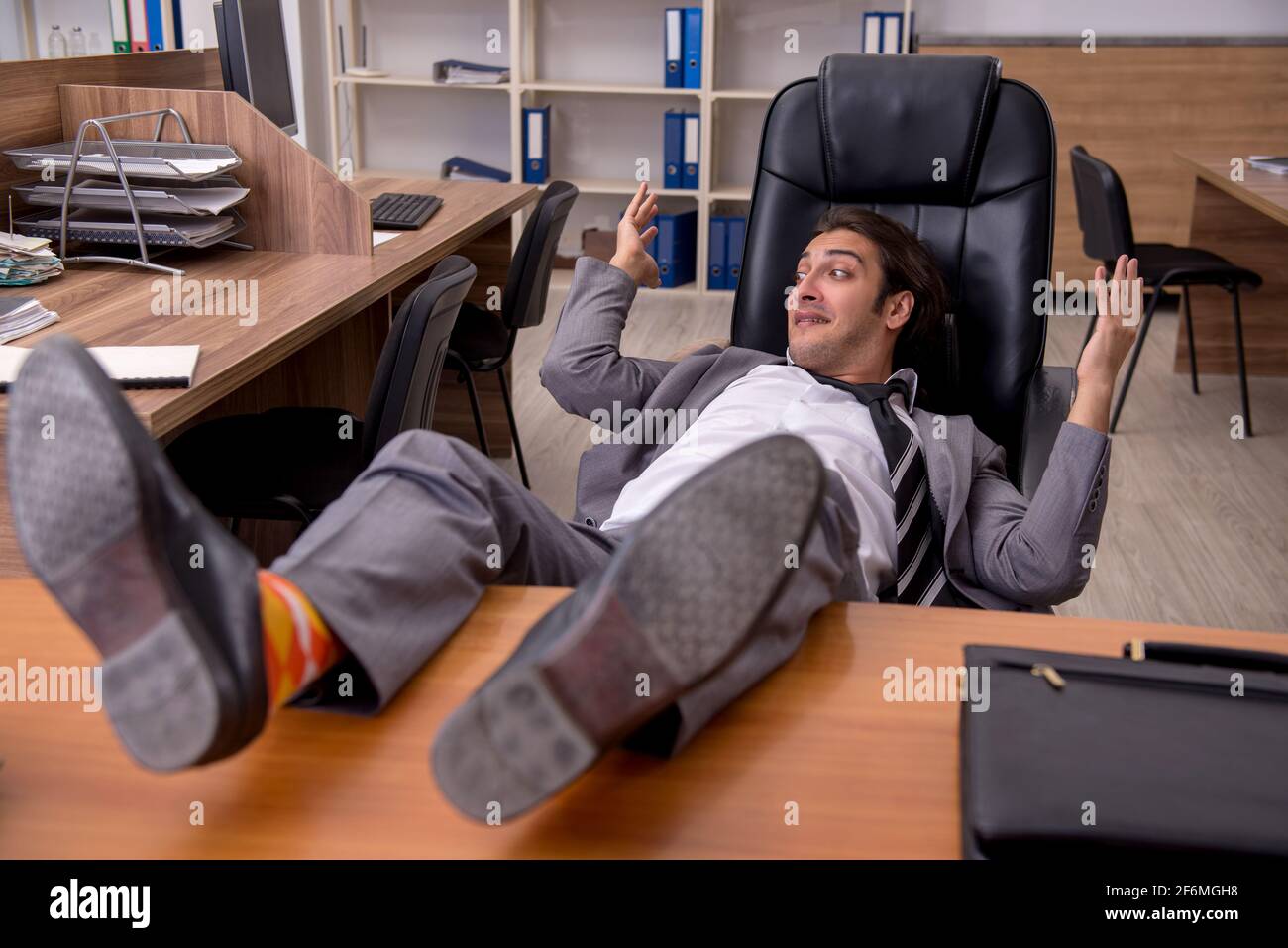 Young employee sleeping at workplace Stock Photo - Alamy