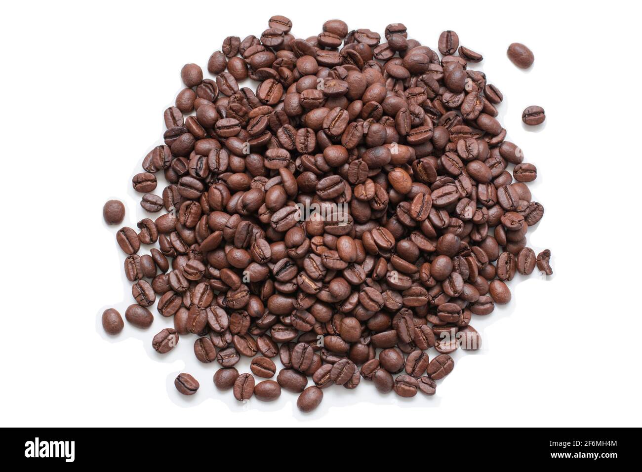 Many coffee beans are heaped. Isolated over white background Stock ...