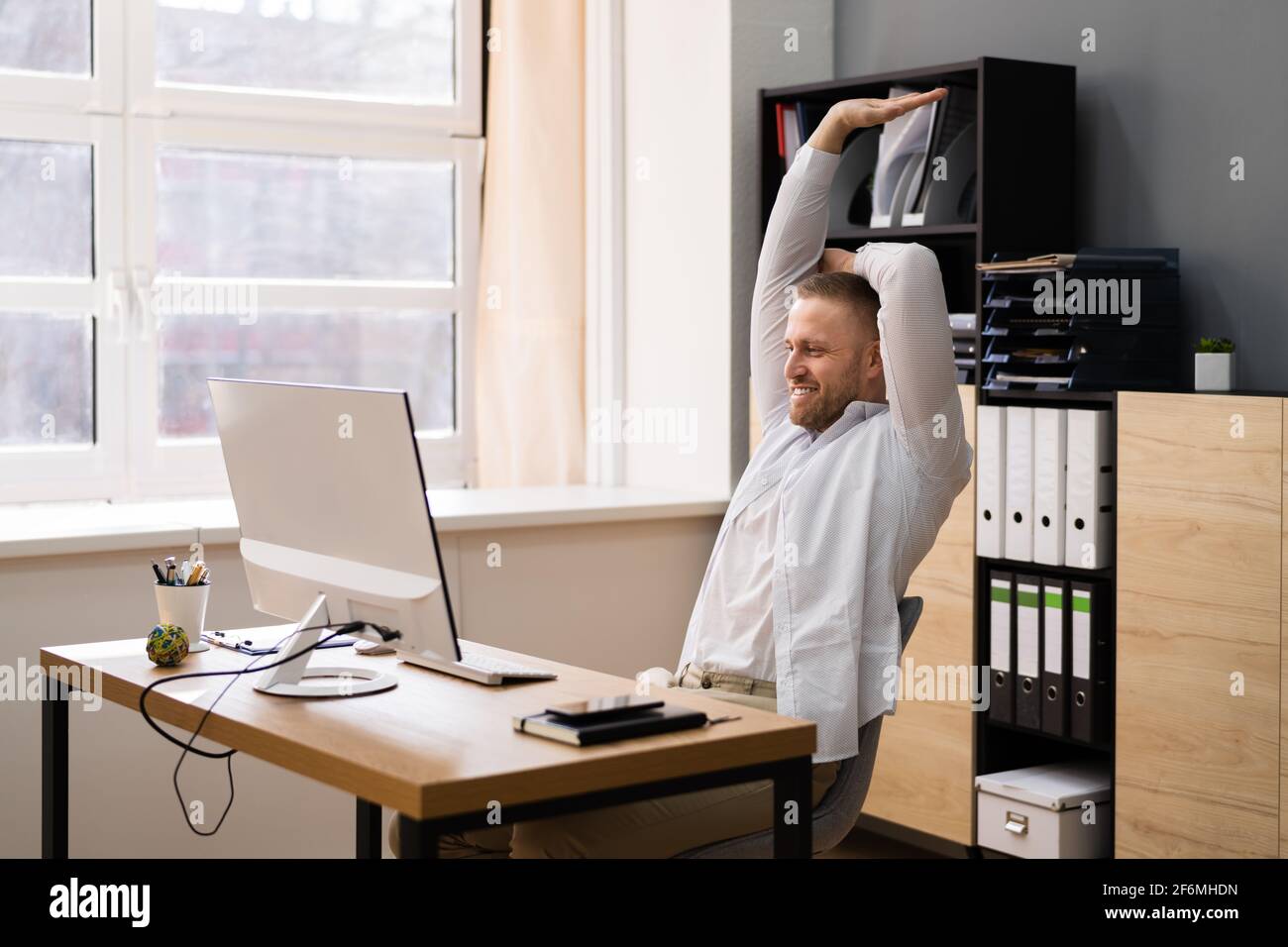 Stretch Exercise At Office Desk. Businessman At Computer Stock Photo ...