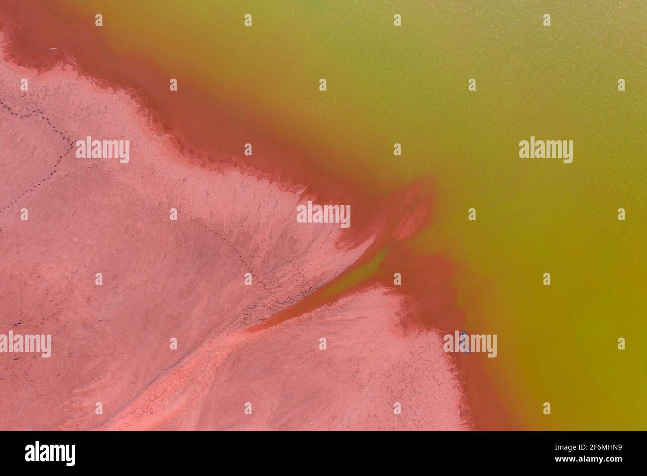 Neszmély, Hungary - Aerial view of drought red mud surface with green ...