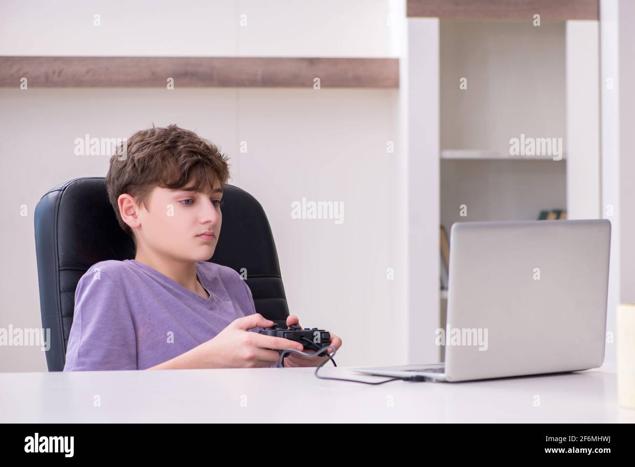 Boy playing computer games at home Stock Photo - Alamy