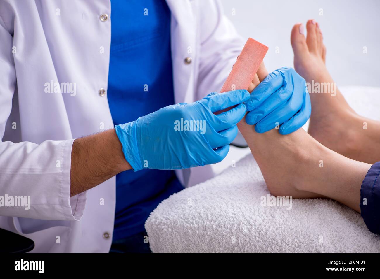 Podiatrist massaging leg patient hi-res stock photography and images ...