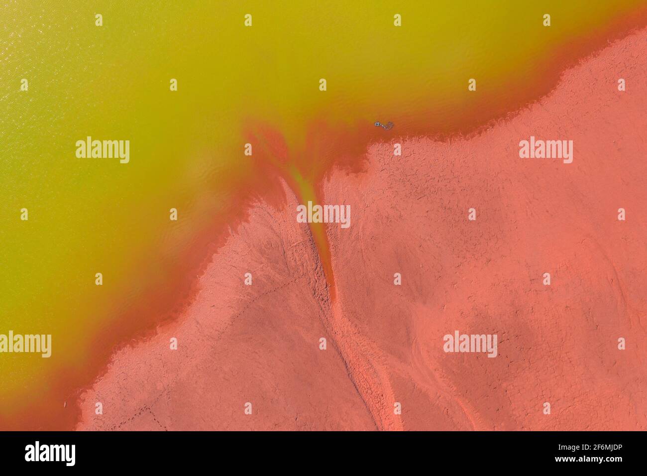 Neszmély, Hungary - Aerial view of drought red mud surface with green ...
