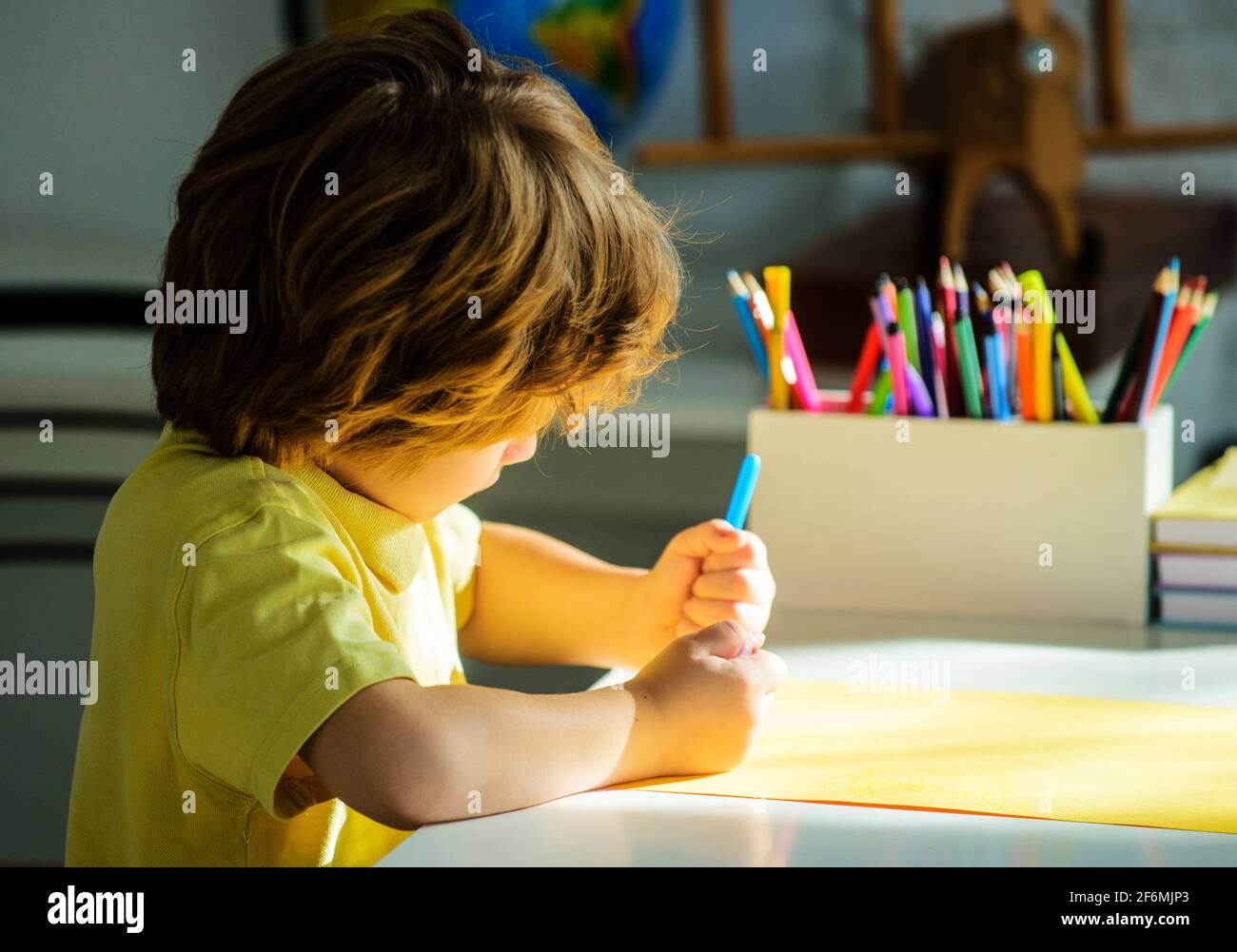 Education concept. Elementary school. Child boy write homework. Primary ...