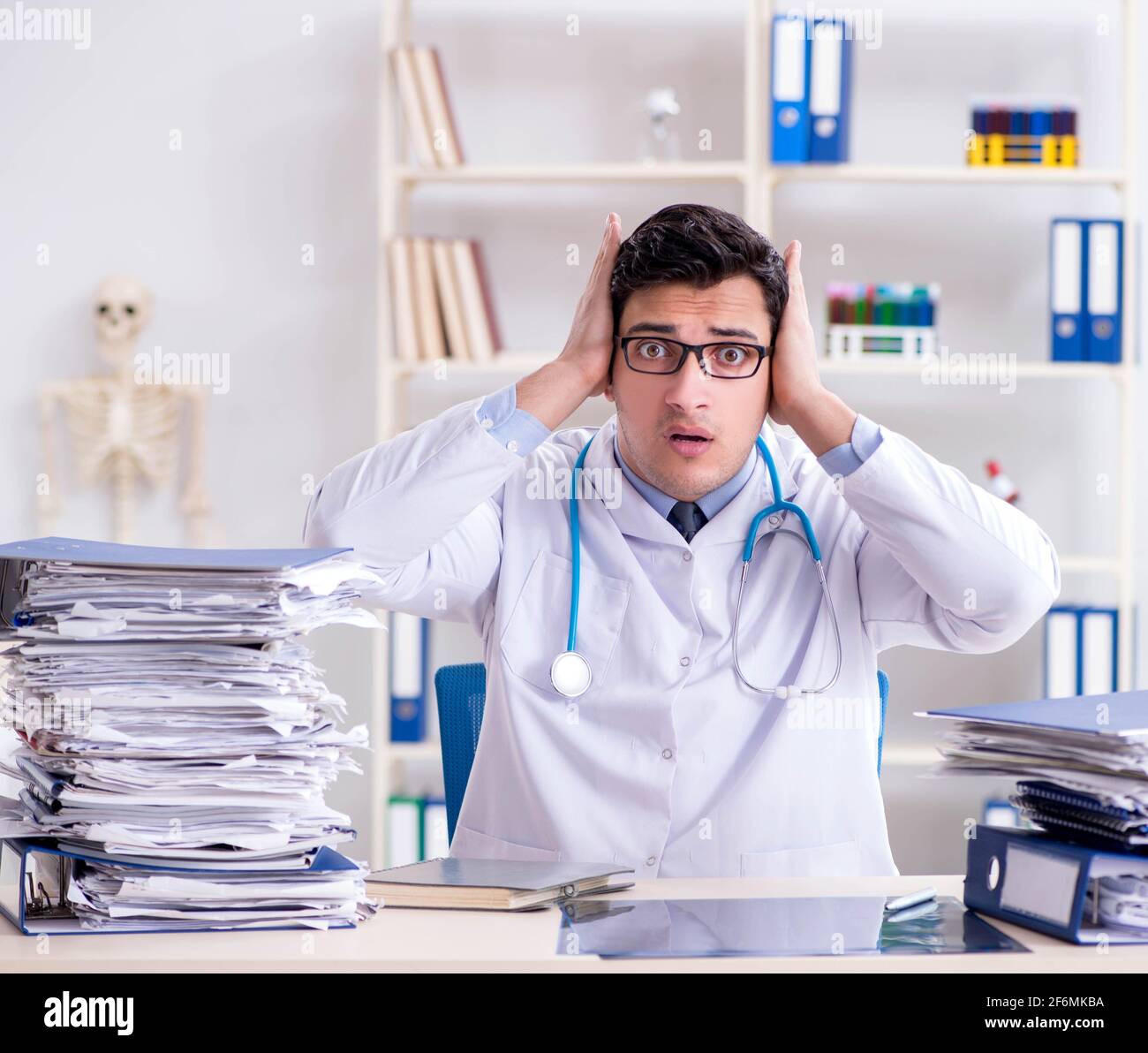 The busy doctor with too much work in hospital Stock Photo - Alamy