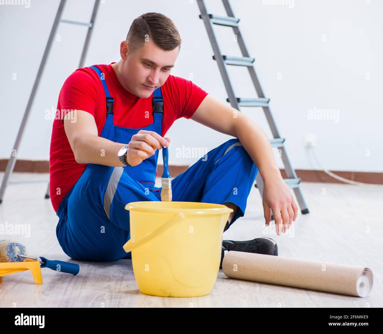 The male painter preparing for painting job at construction site Stock ...