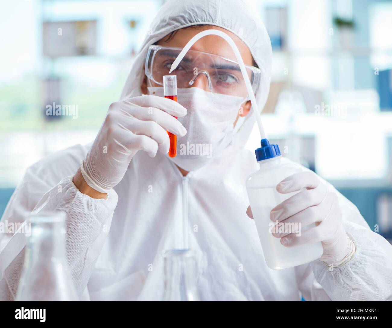 The chemist working in the laboratory with hazardous chemicals Stock ...