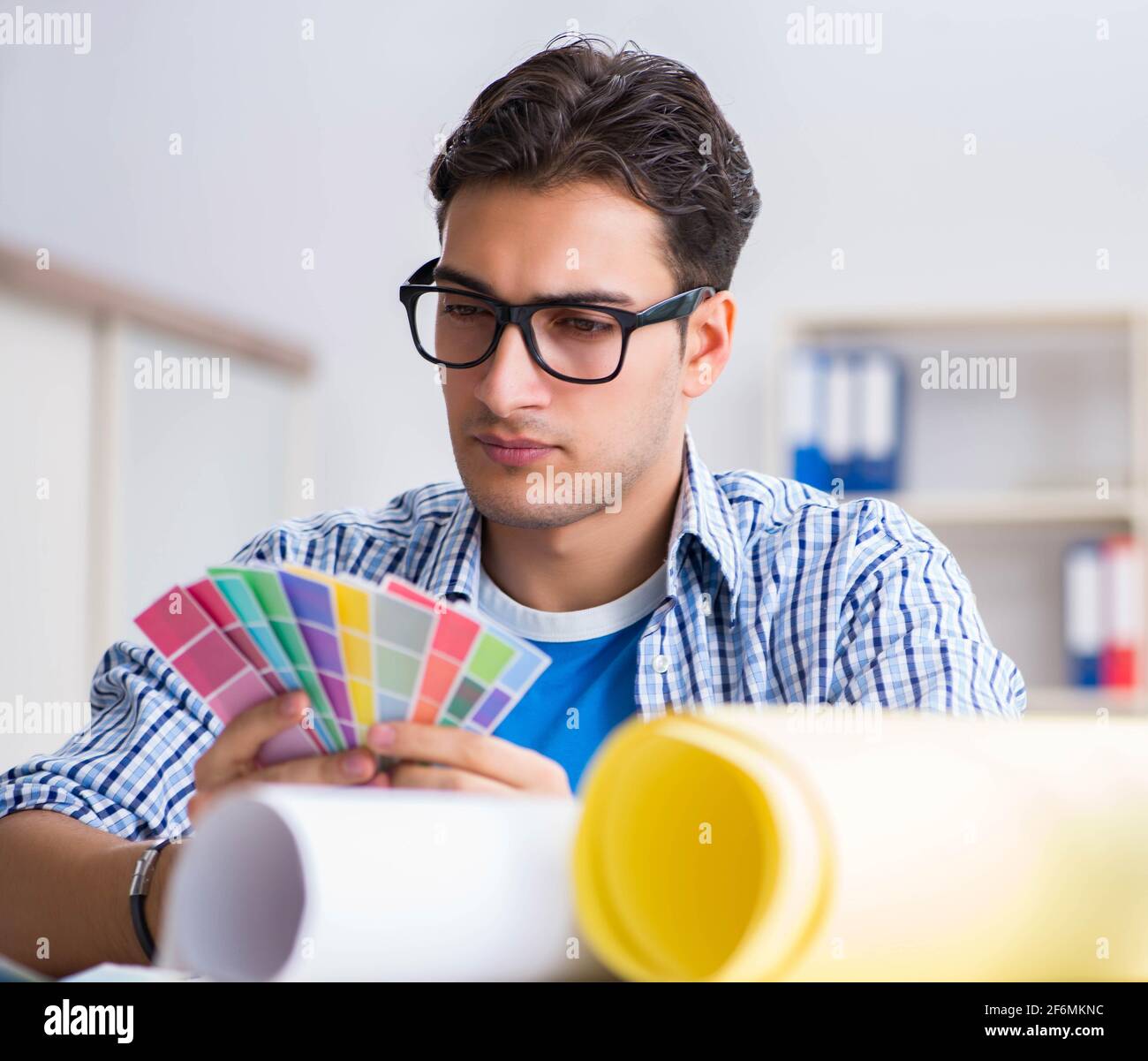 The young designer working on new project and choosing colours Stock ...