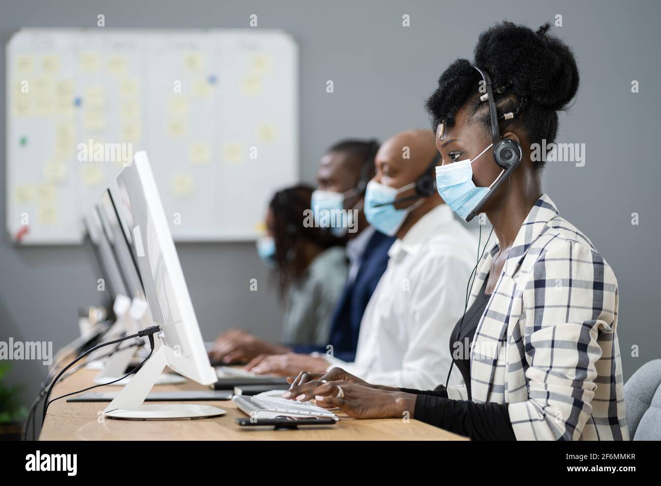Customer Service And Contact Center In Covid Mask Stock Photo - Alamy