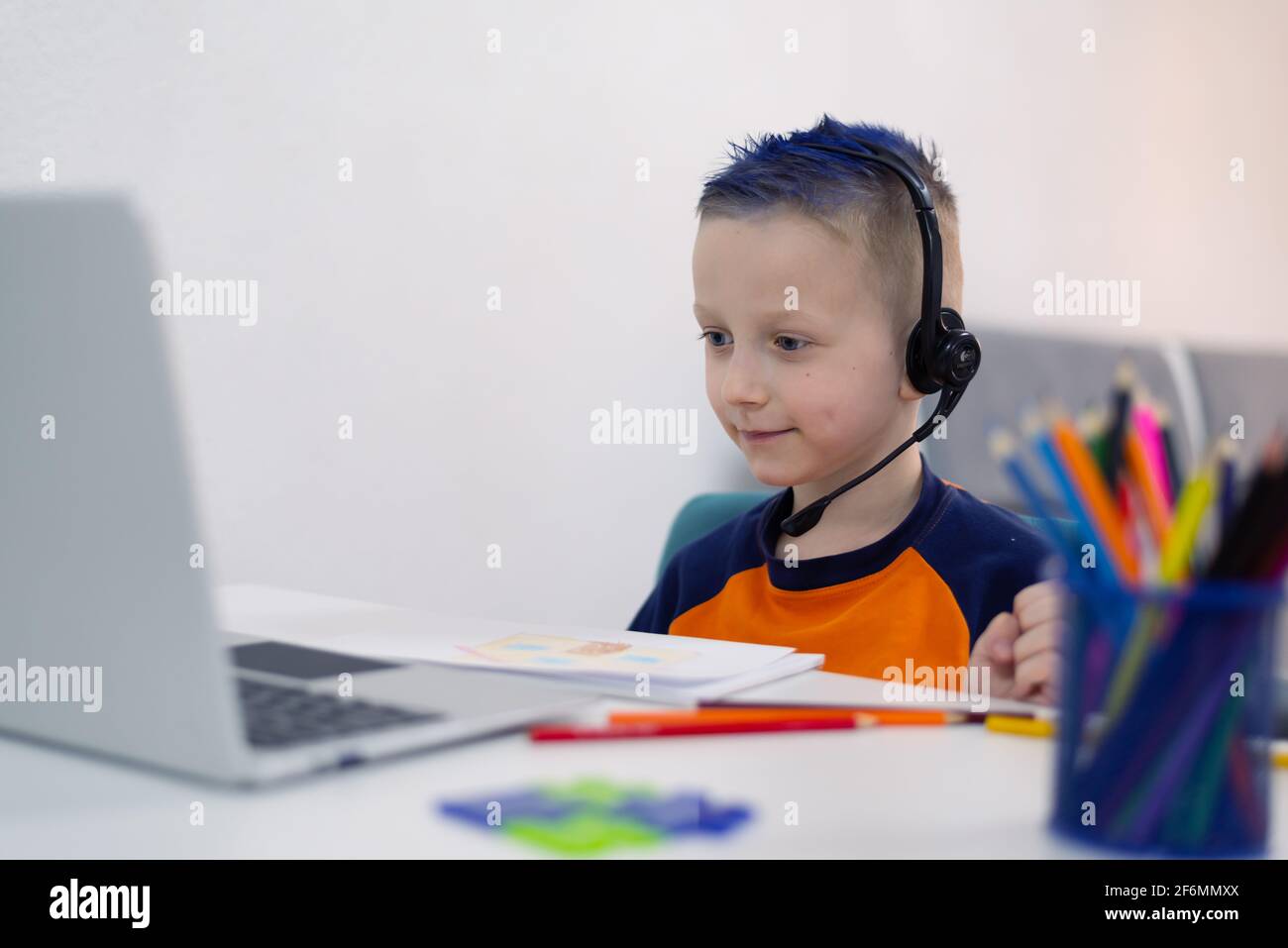Distance learning and online education. Schoolboy boy studies at home ...
