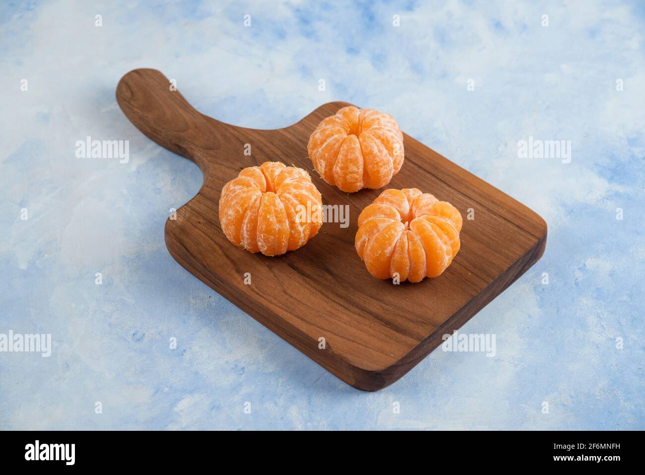 Close up photo of three peeled mandarins Stock Photo - Alamy