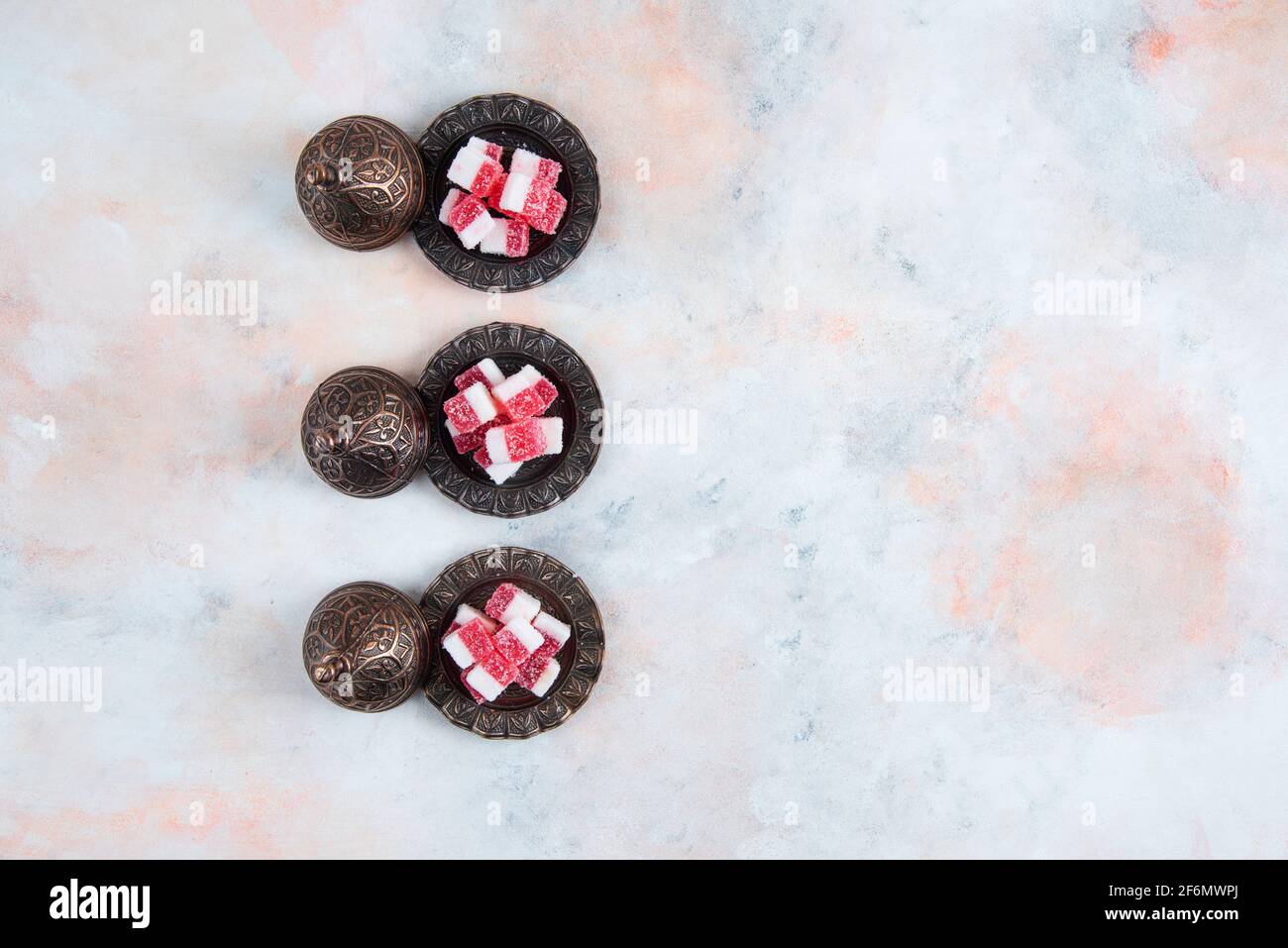Candy crockery in a row over white background Stock Photo - Alamy