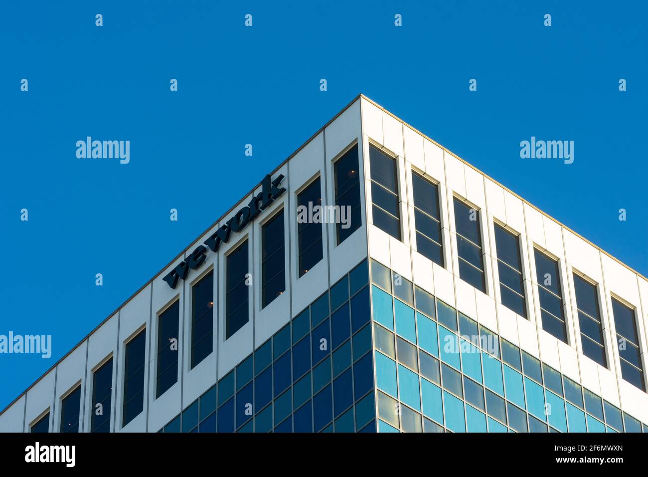 WeWork sign on shared coworking space building. WeWork is an American ...