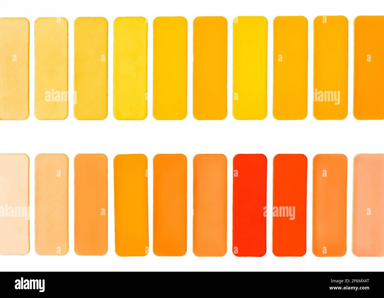 Samples of different shades of yellow and orange in squares on a white ...