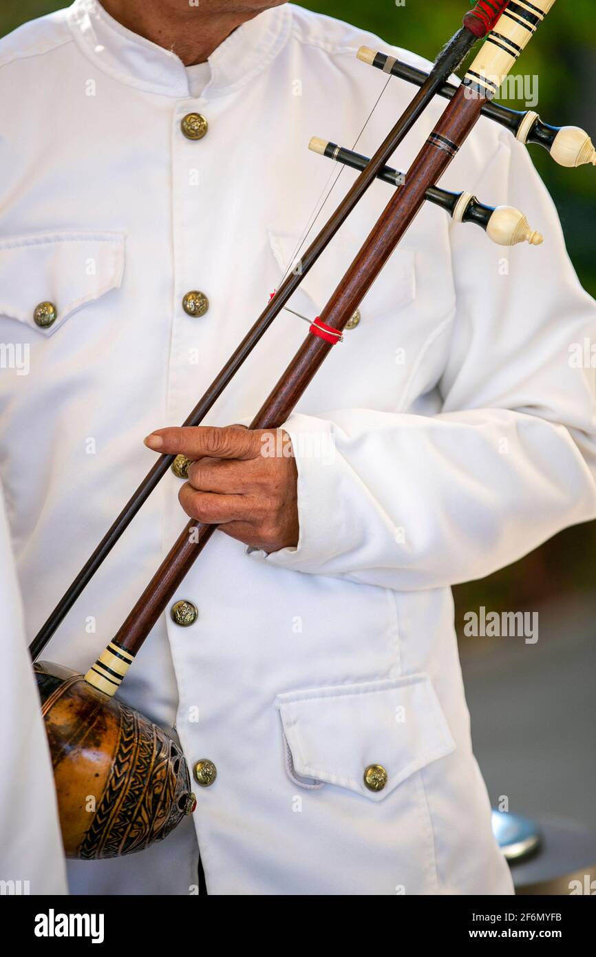 Spike fiddle, Tro, being played by a musician at a Cambodian wedding ...