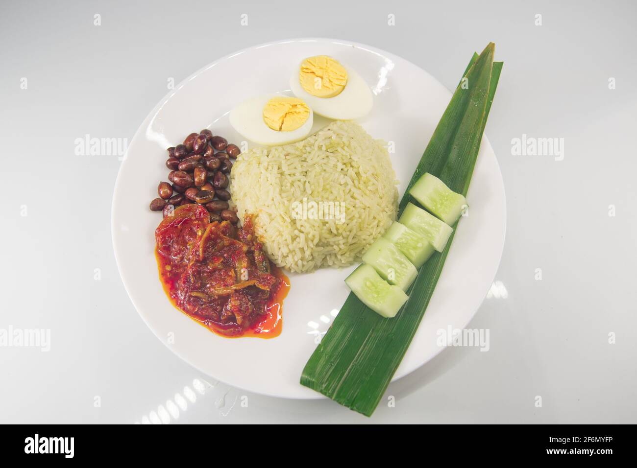Nasi lemak with pandan rice (Malay fragrant rice dish cooked in coconut ...