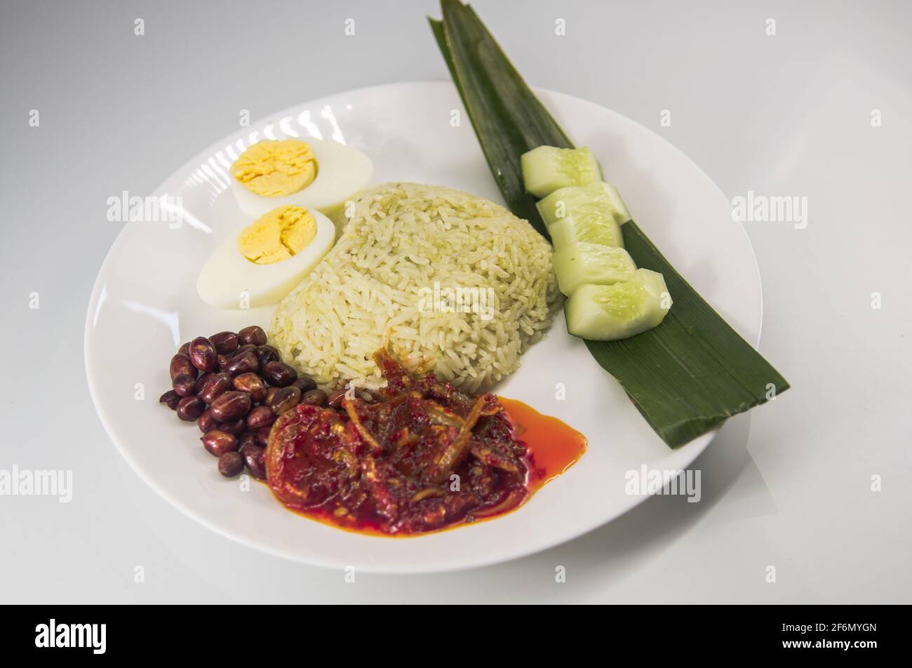 Nasi lemak with pandan rice (Malay fragrant rice dish cooked in coconut ...