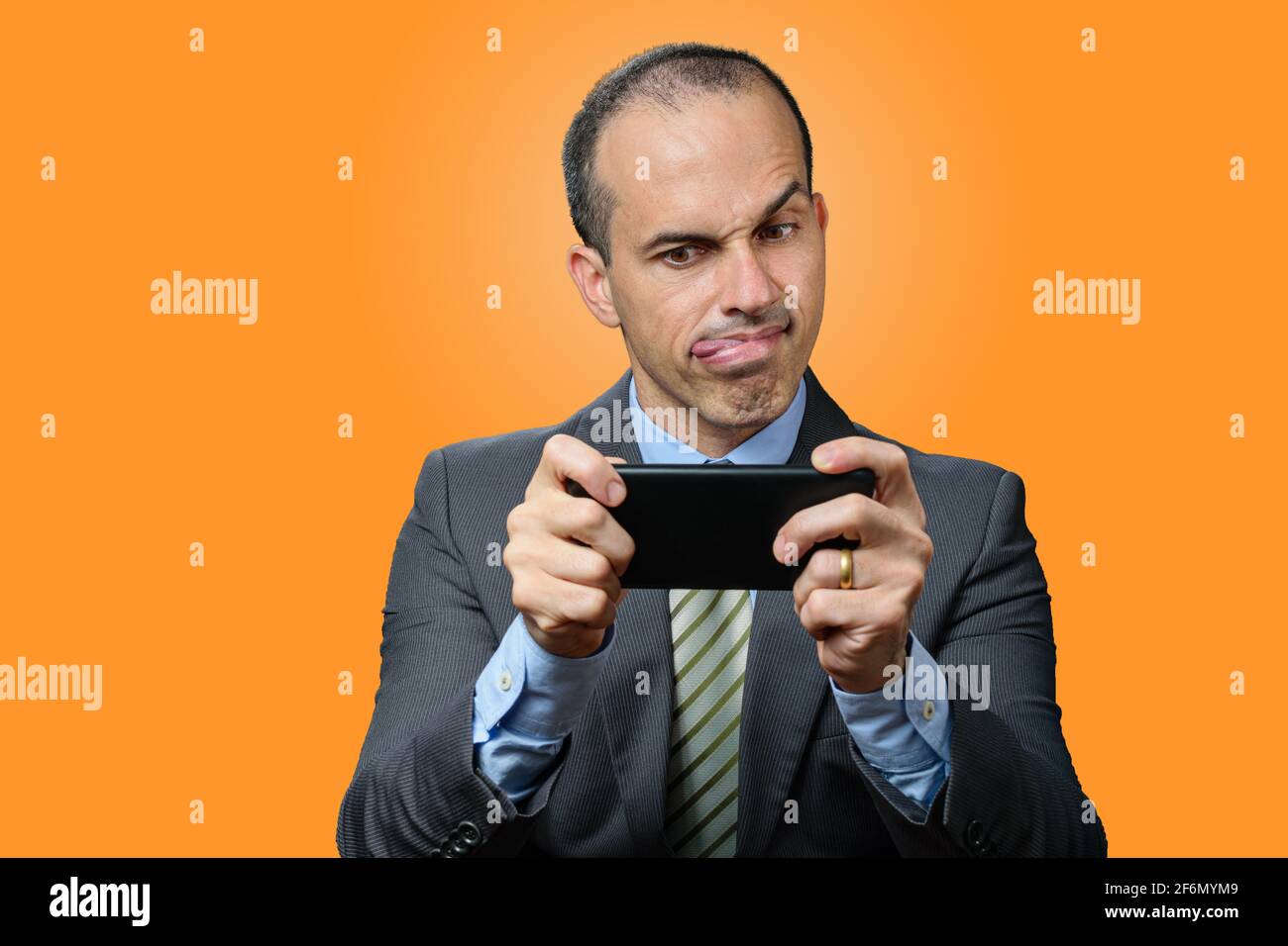 Man biting tie hi-res stock photography and images - Alamy