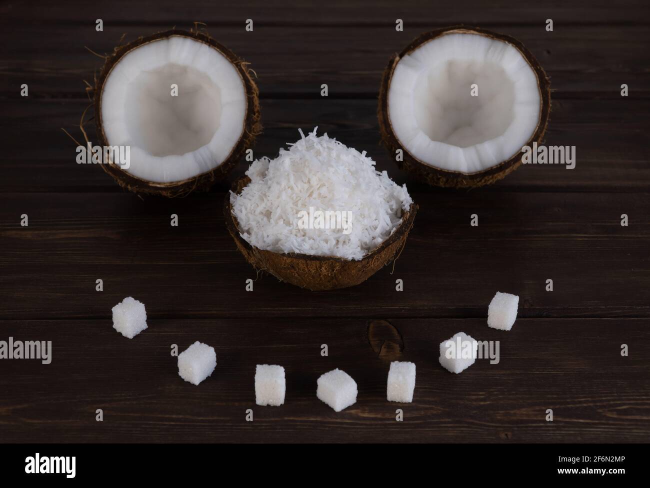 split coconut on wooden planks. selective focus. nut peel is filled ...