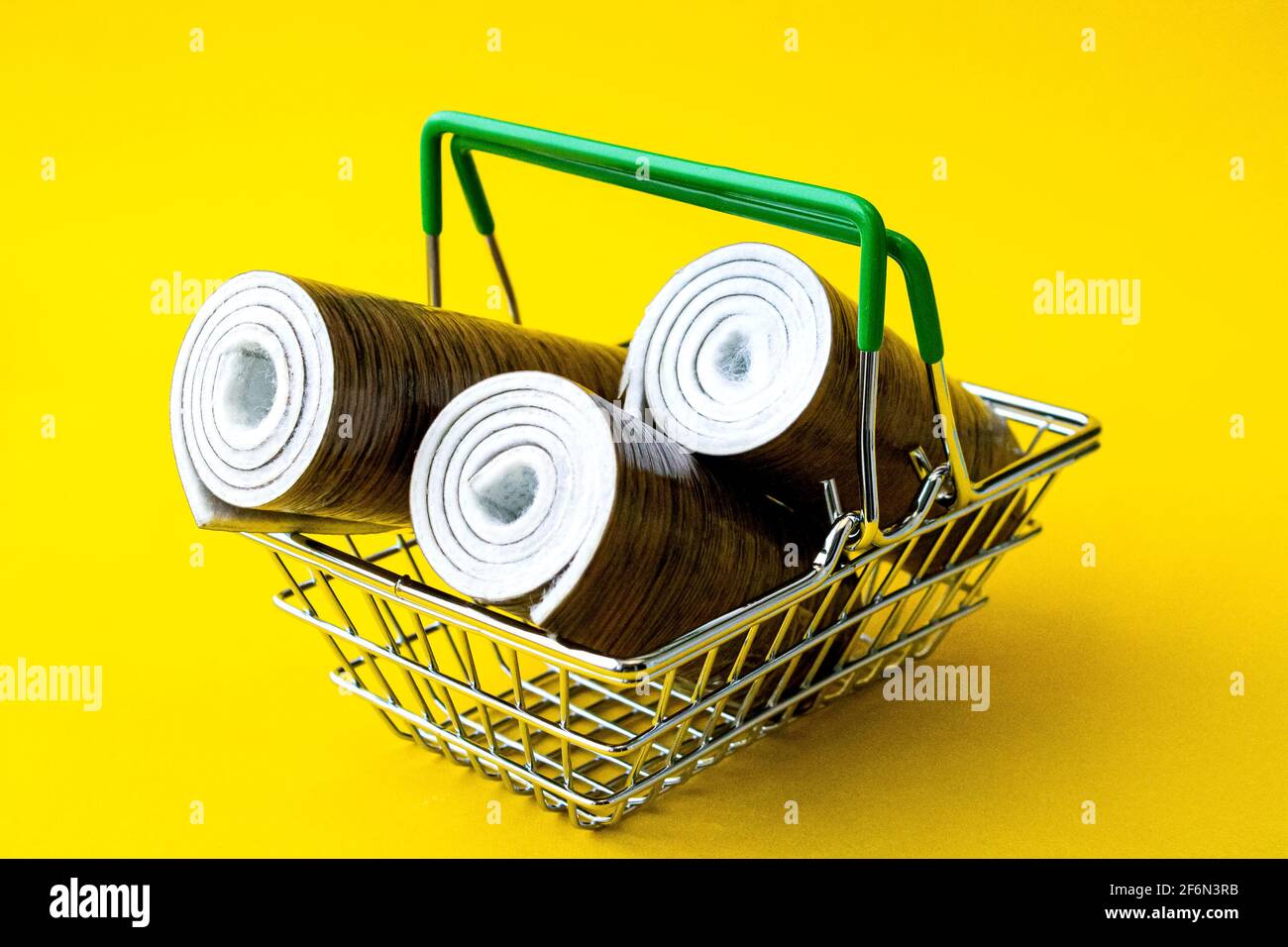 Linoleum in a shopping basket. In a flooring store. Linoleum purchased ...