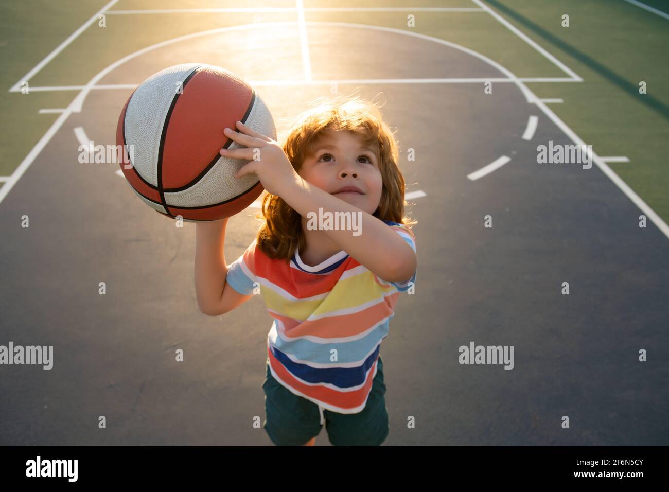 Happy little boy kid playing basketball on playground. Sport for kids ...