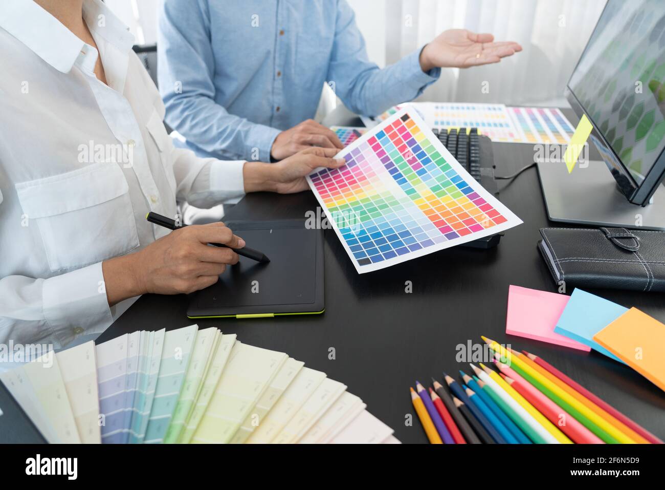graphic designer team working on web design using color swatches ...