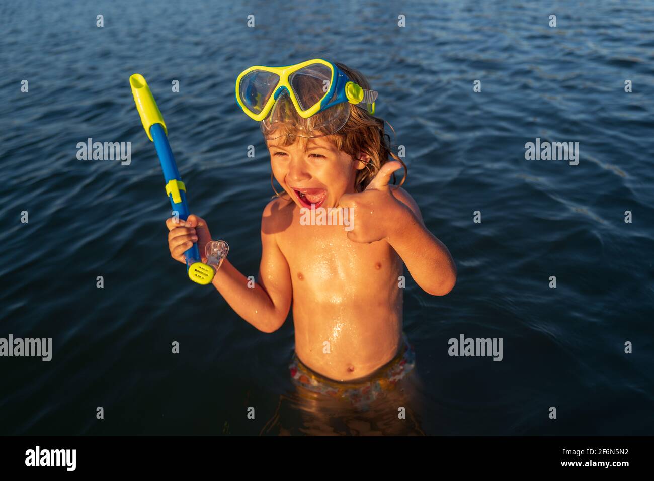 Boy kid swimming on the beach on summer vacation. Child in sea. Happy ...