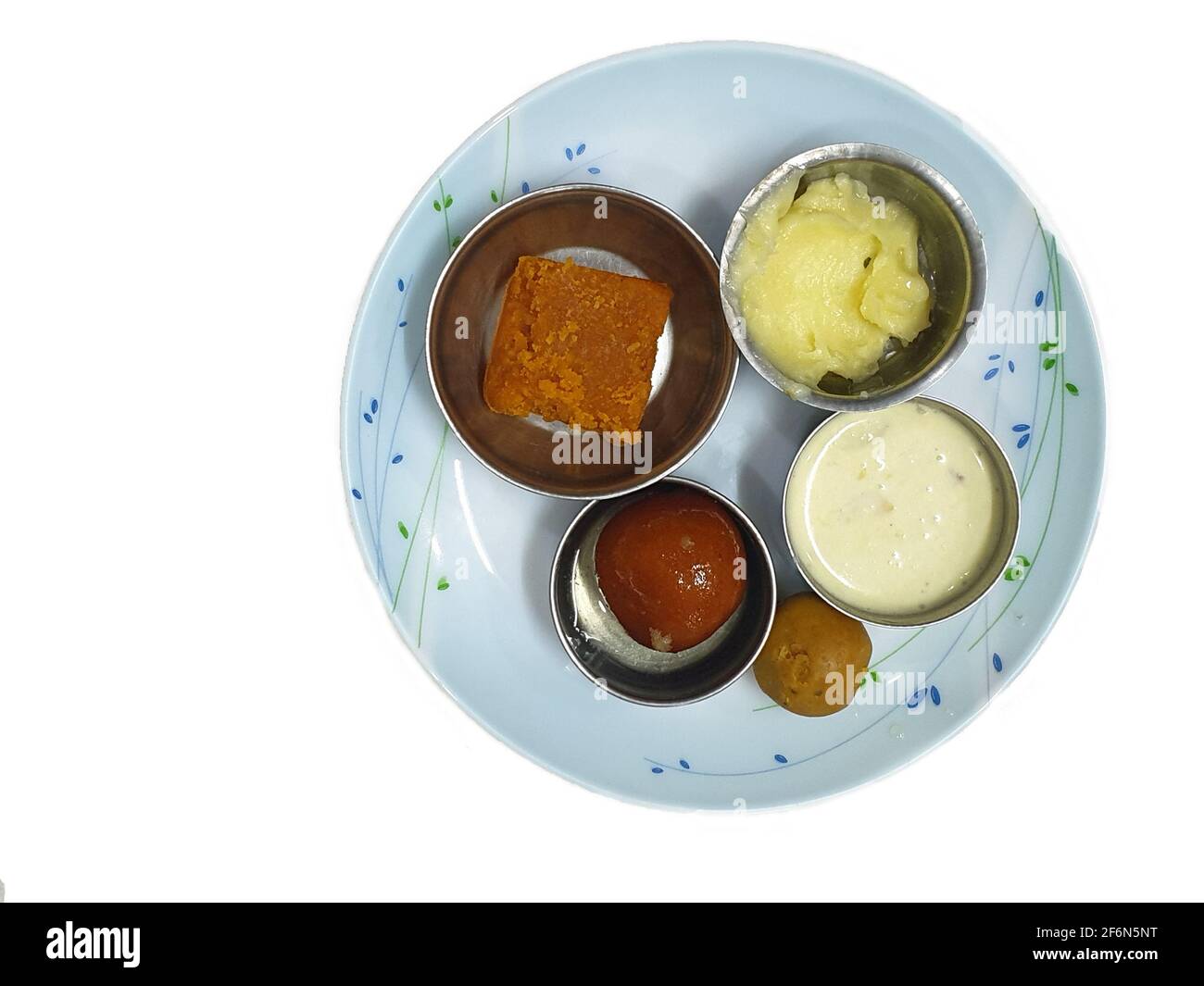 Five different Indian Sweets like barfi, laddoo, shrikhand, kheer and ...