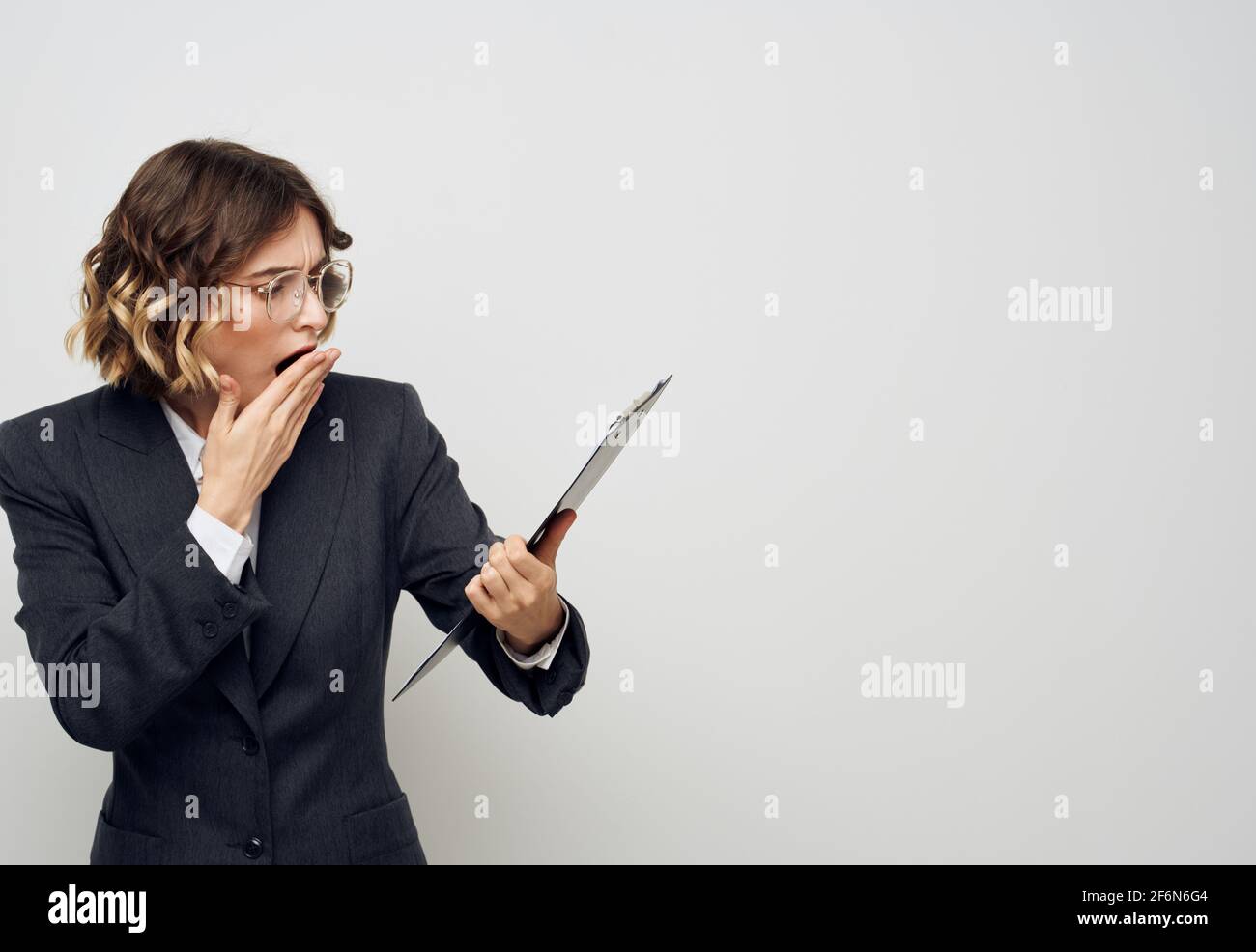 Puzzled woman with documents in hands job office mockup Stock Photo - Alamy