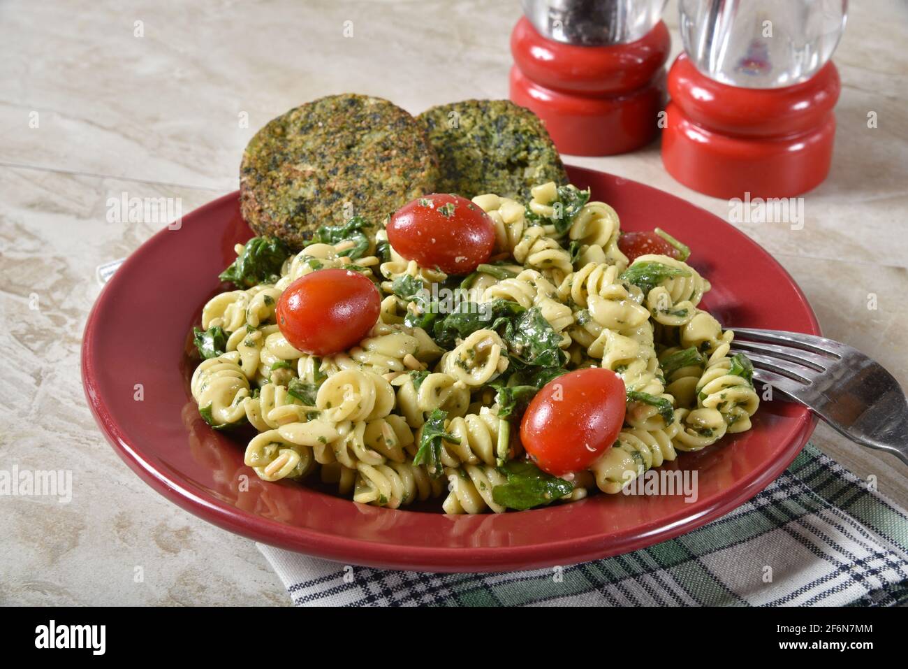 Rotini pasta salad with spinach cakes and grape tomatoes Stock Photo ...