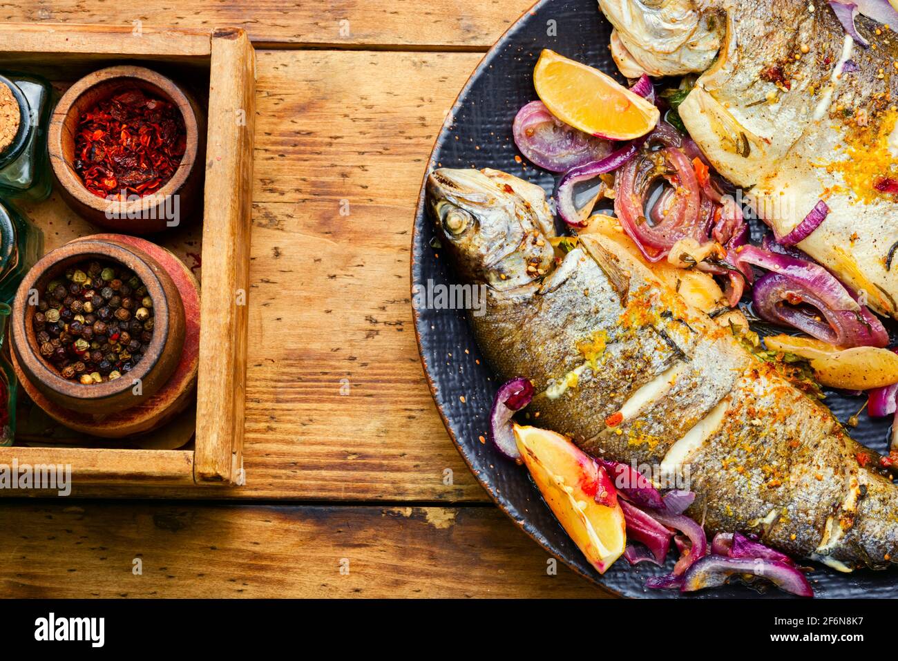 Roasted whole trout with lemon on plate Stock Photo - Alamy